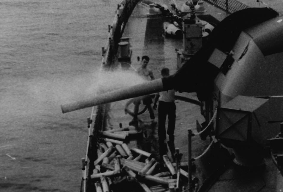 Hosing down 5in gun in USS Beale (DD-471)