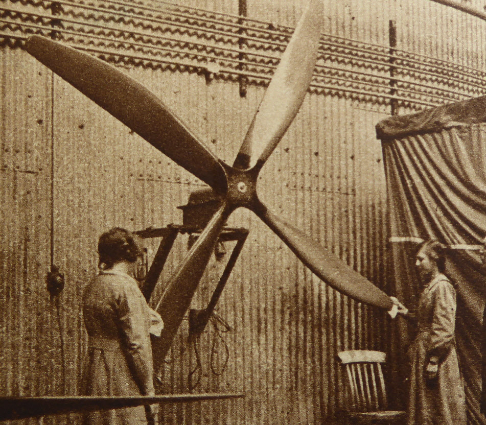 Women testing balance of airship propeller